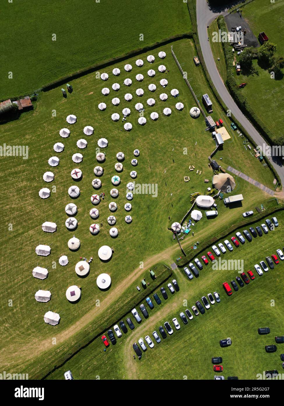 Aerial view of luxury glamping campsite with yurts tipis and tents near ...