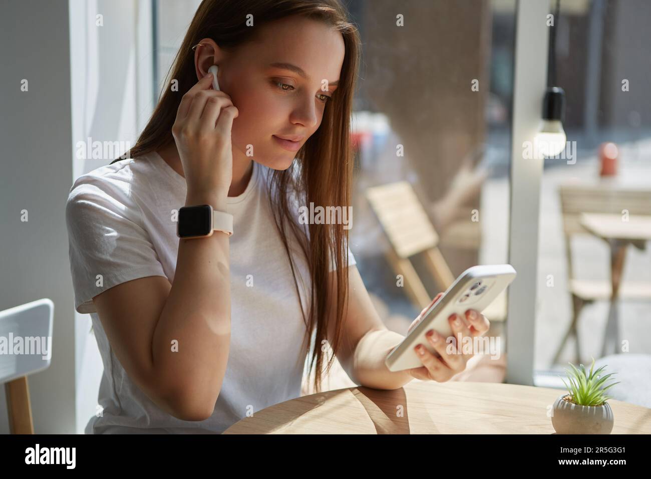 Beautiful female person listening to music streaming service in a ...