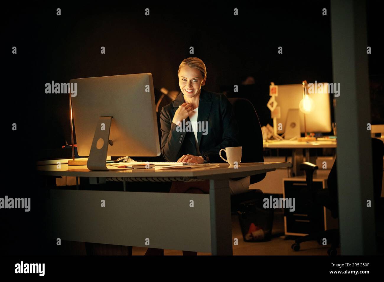 Staying late to finish a last minute project. a mature businesswoman ...