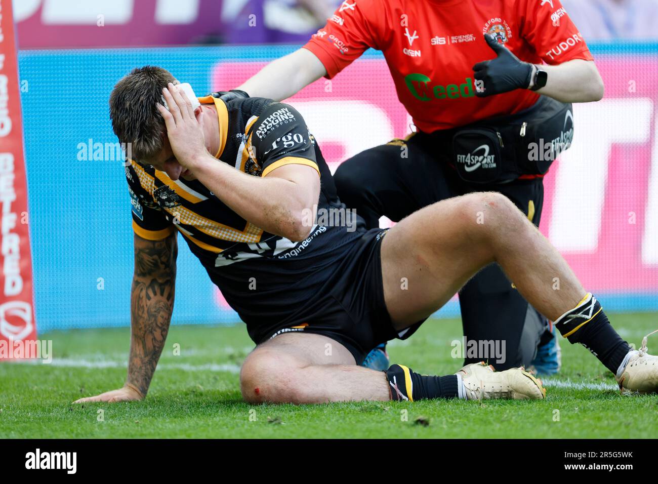 Castleford Tigers' Alex Mellor holds his head as he receives treatment ...