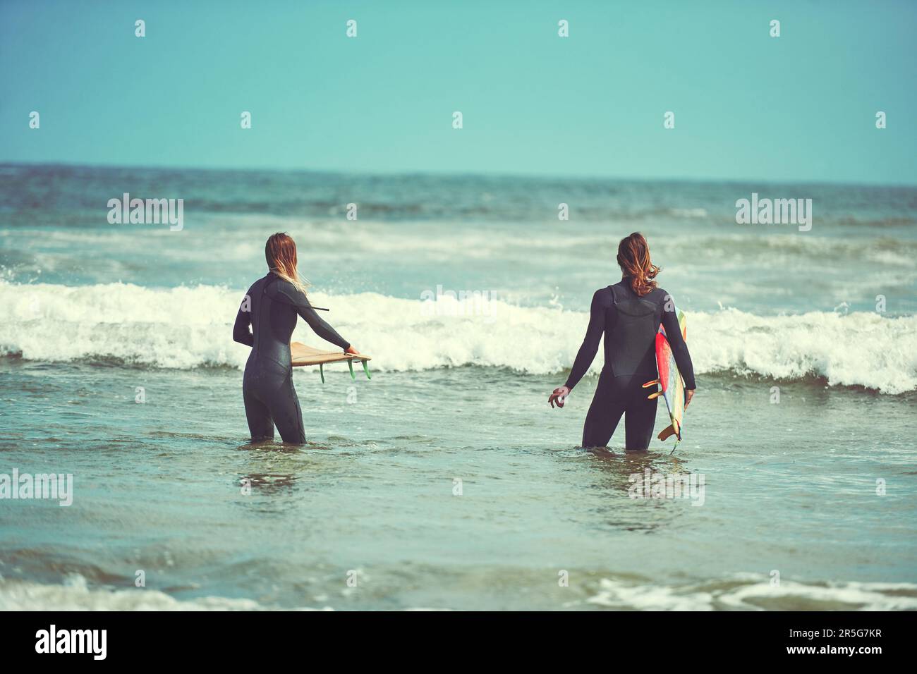 Boyfriends make the best surfing buddys. a young couple surfing at the ...