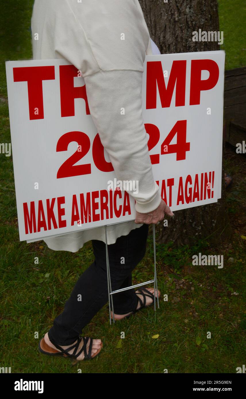 A woman in Abingdon, Virginia, carries a sign promoting Donald Trump ...