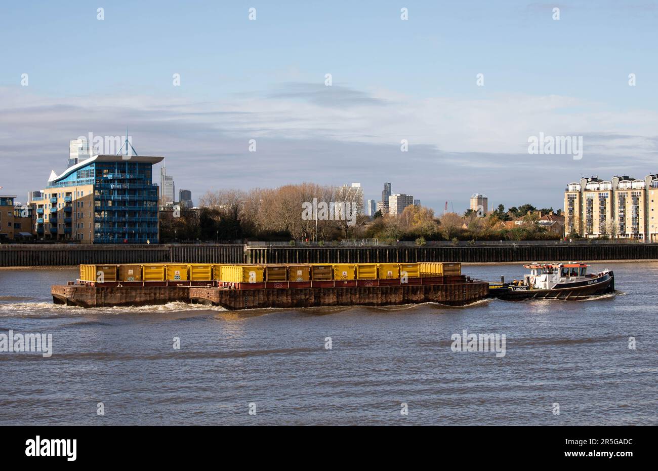 London, UK - November 18 2020: The Reclaim tugboat pulls 2 barges ...
