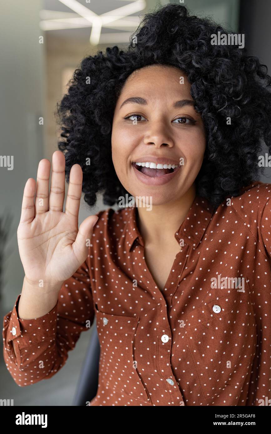 Vertical shot, young beautiful african american business woman with ...