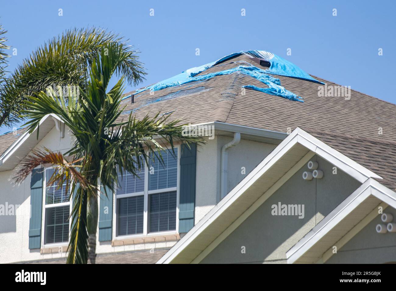 Destroyed Tarp on the roof waiting to get repaired Stock Photo - Alamy