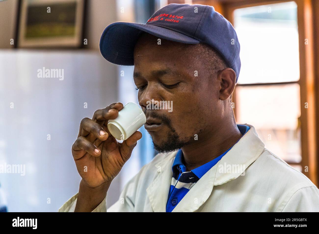 Production manager Chisomo Custom tasting new batches of tea. Every ...