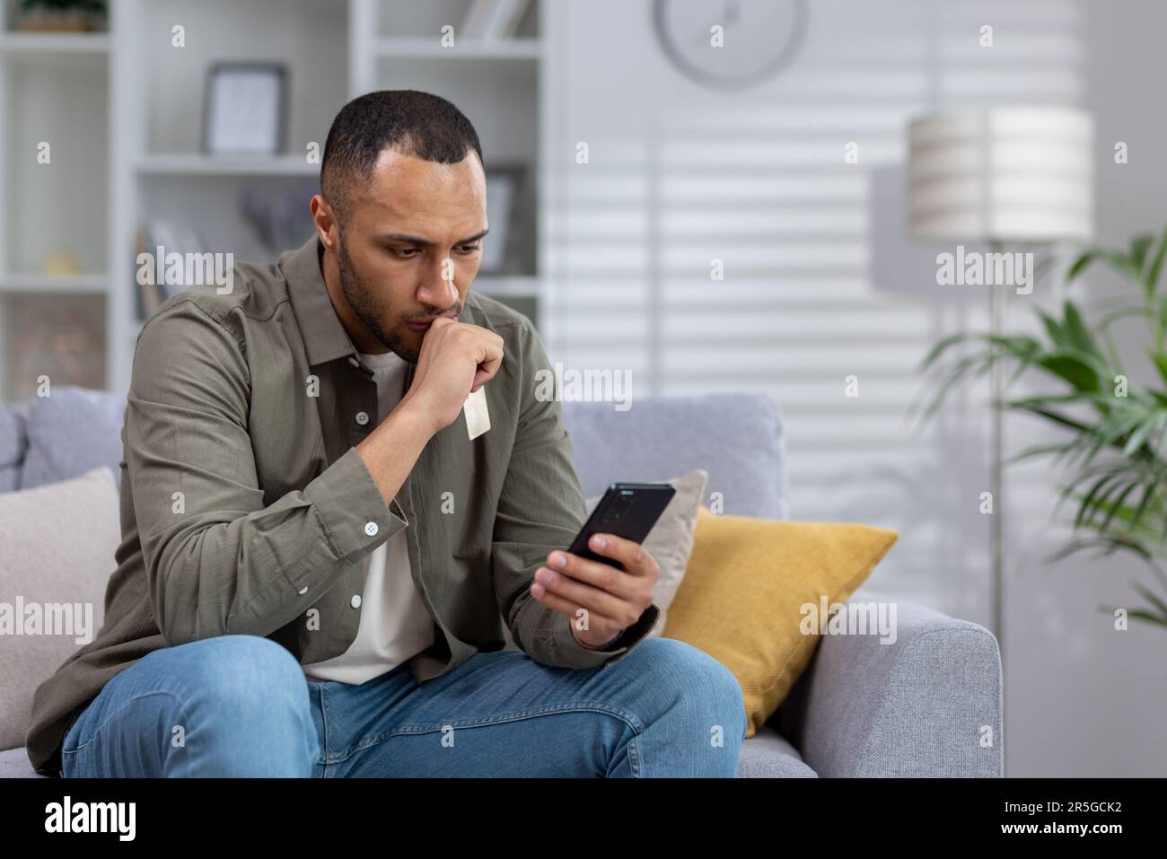 A young African American man received bad news, a message on his cell ...