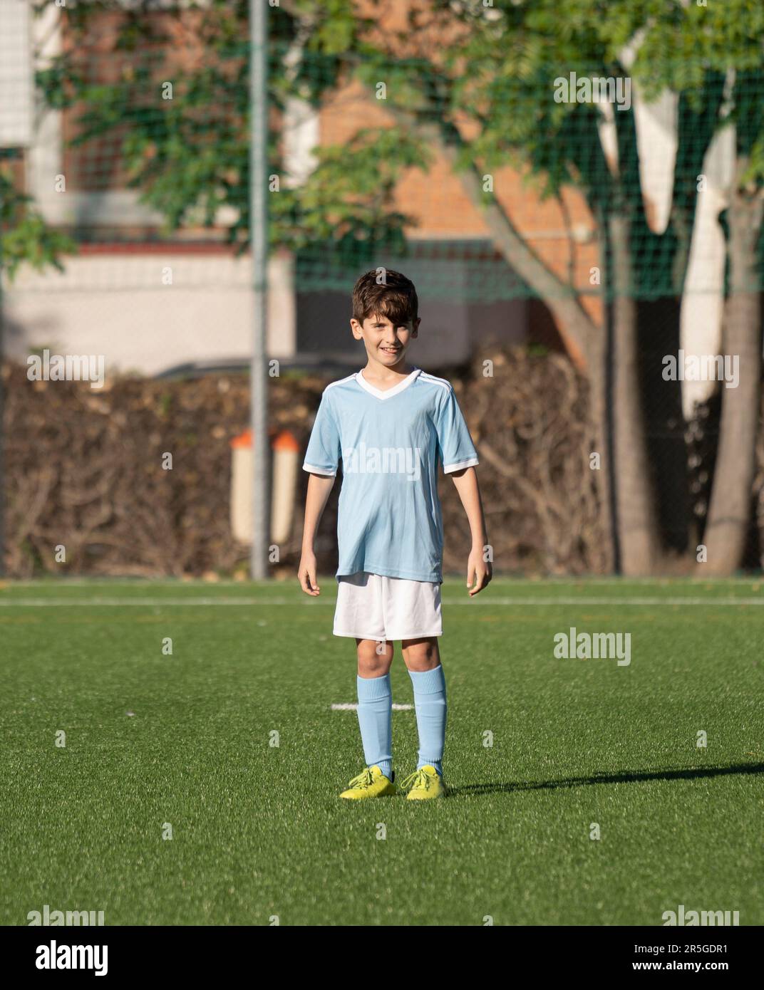 A happy young boy football player on the field.Portrait of a smiling ...