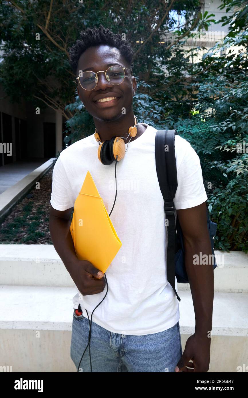 Cheerful African student looking camera confident while standing at ...