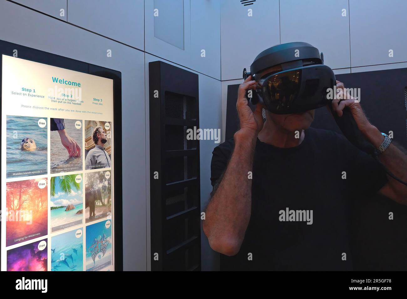 A passenger watches VR content through virtual reality goggles at the ...