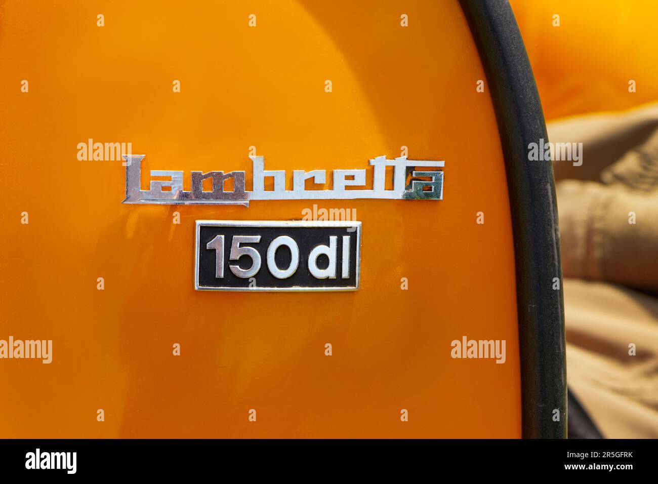 close up of chrome lambretta 150 dl badge on orange moped at vintage ...
