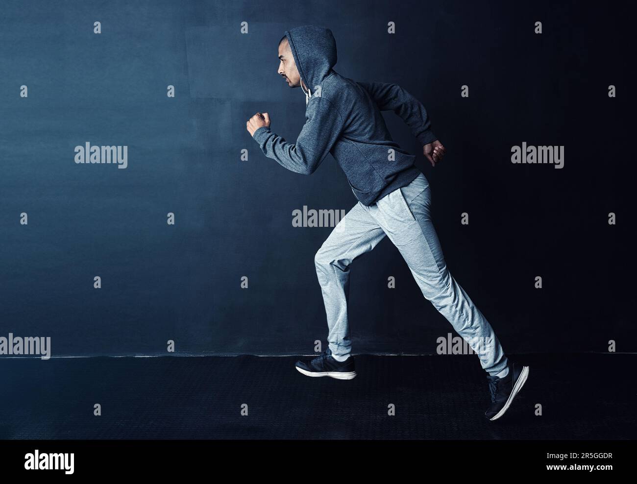 One foot forward. Studio shot of a sporty young man running against a ...