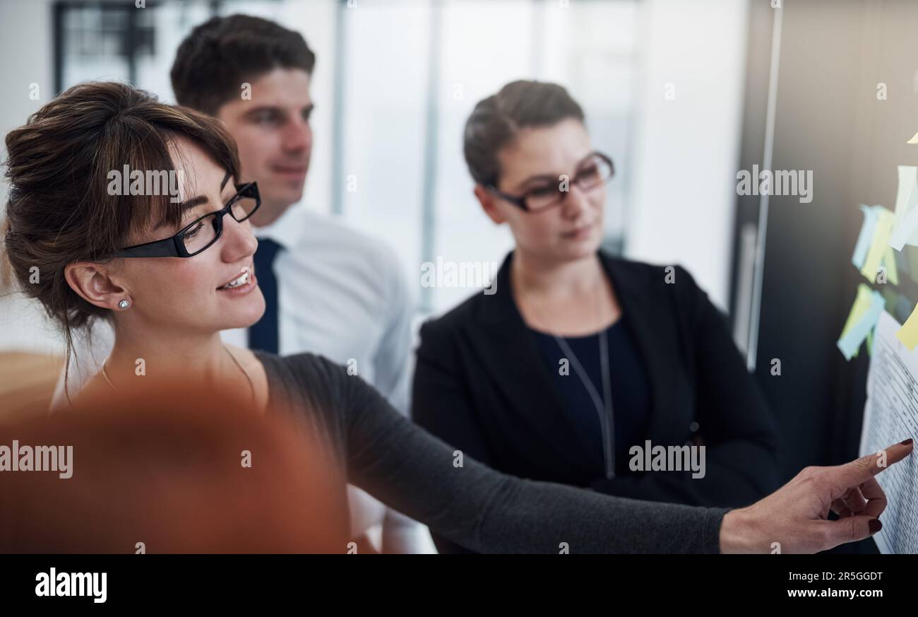 Taking a look at their updated plans together. a group of ...