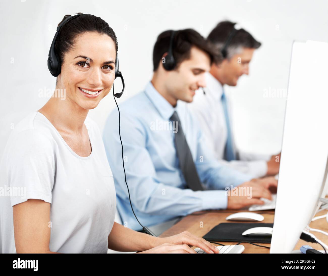 Working together to provide good service. Positive customer service agents at work while wearing ...