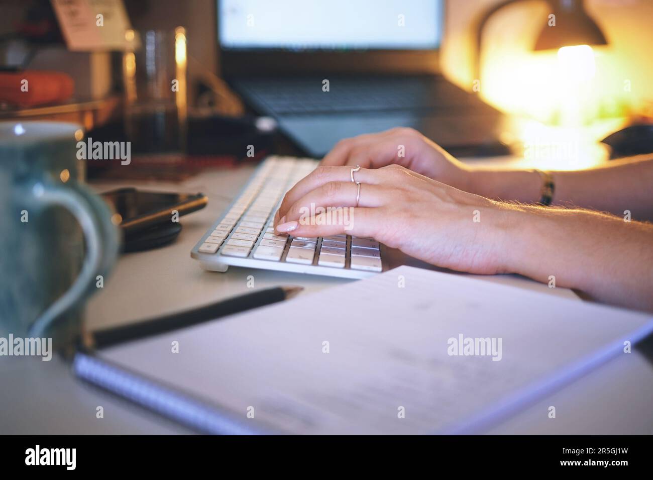 My emails pile up overnight. an unrecognizable woman sitting alone and ...