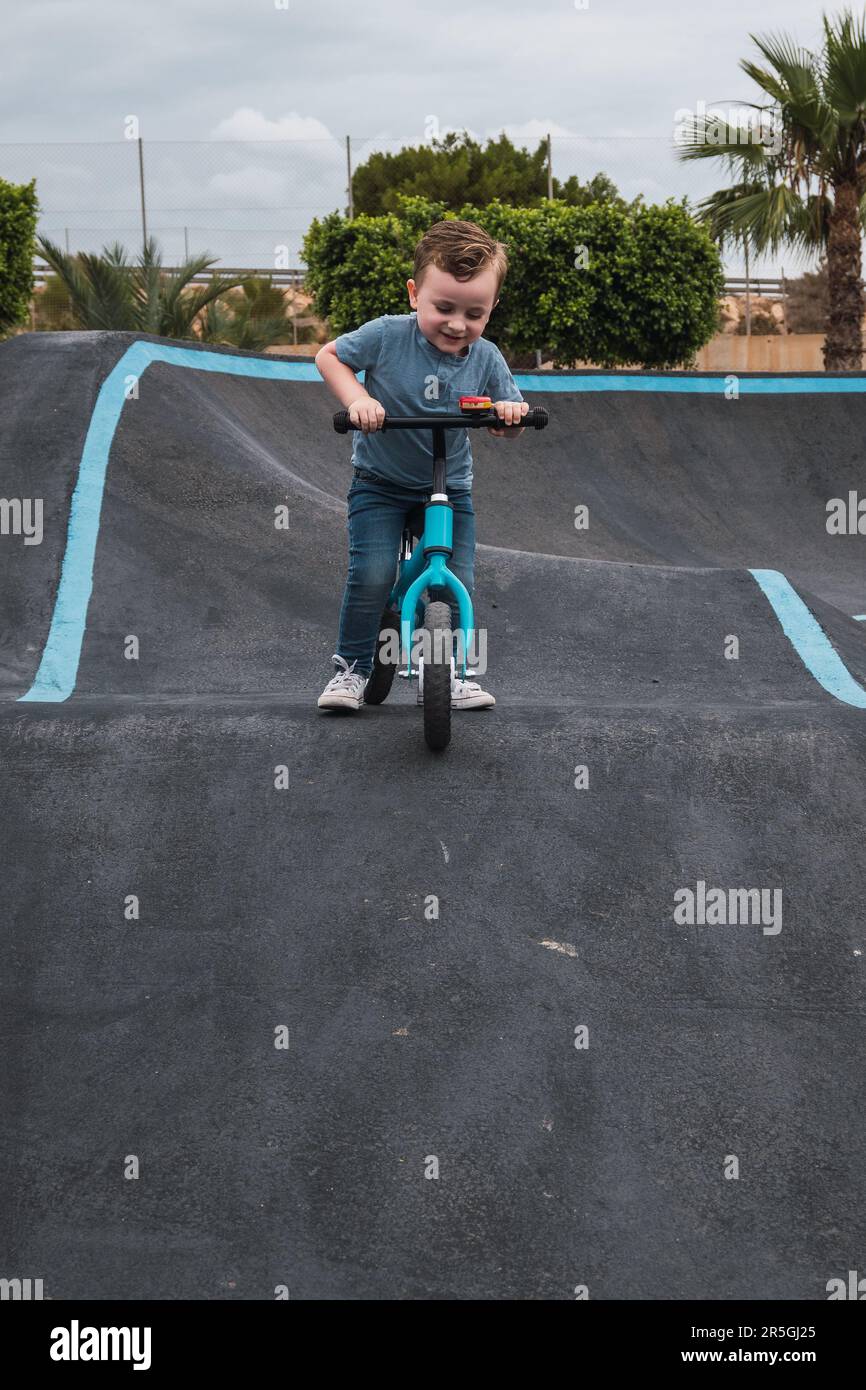 A young child rides the new South Glenmore Park BMX pump track on his ...
