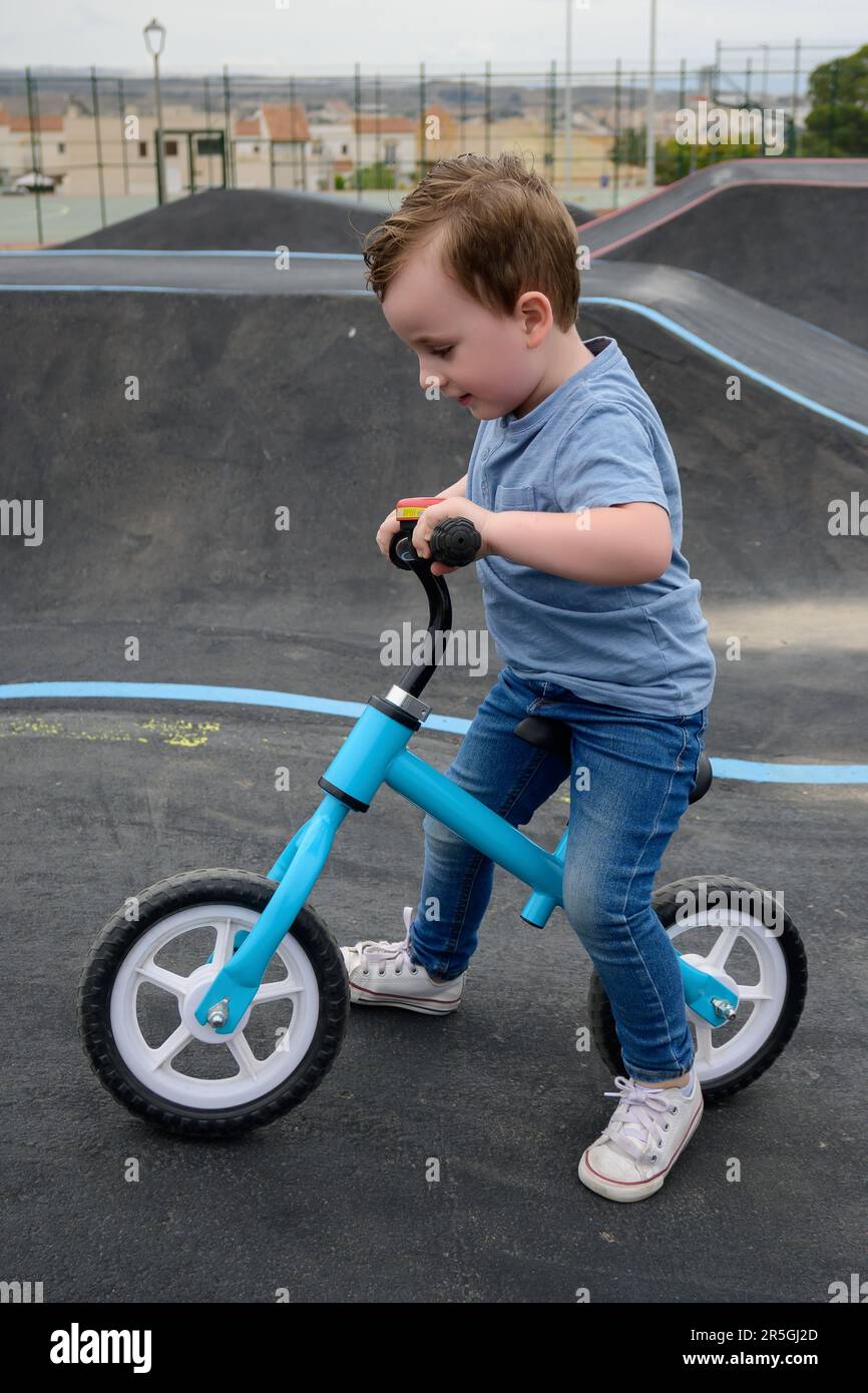 A young child rides the new South Glenmore Park BMX pump track on his ...