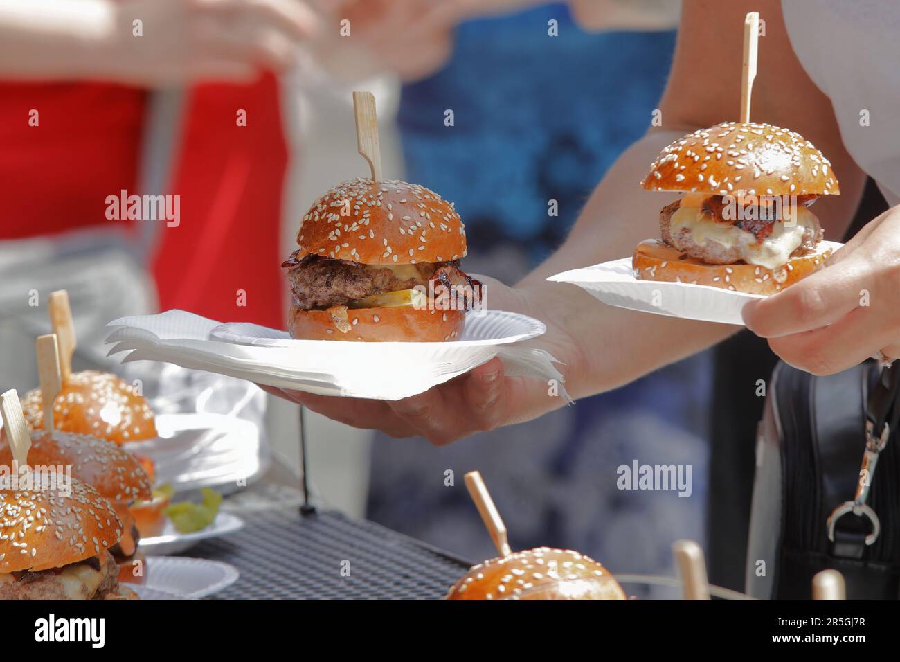 A customer takes the burgers she has bought from the farmars market ...