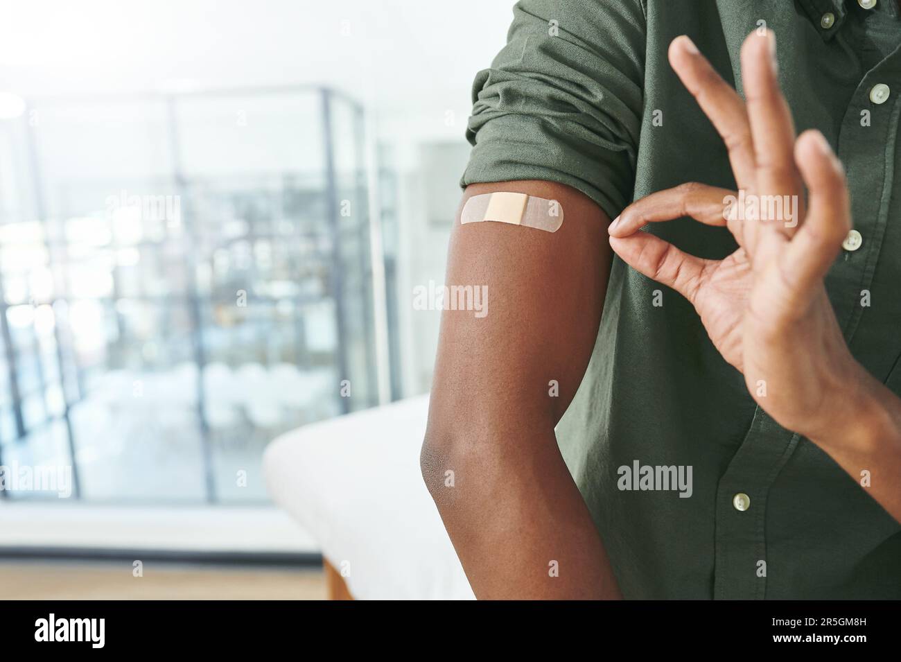 Everything is great. an unrecognizable persons arm with a band-aid ...