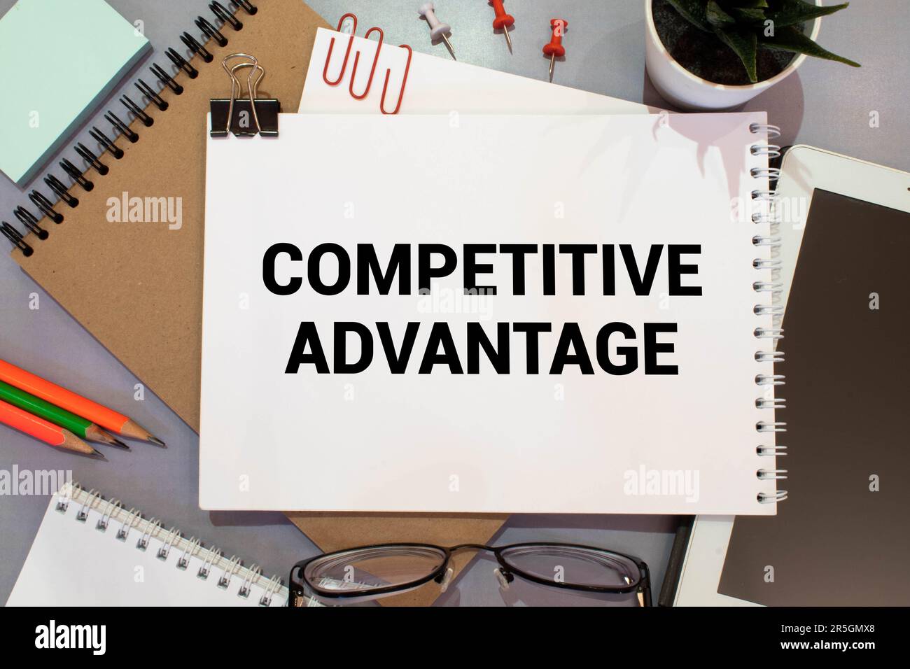 Business man pointing to transparent board with text: Competitive ...