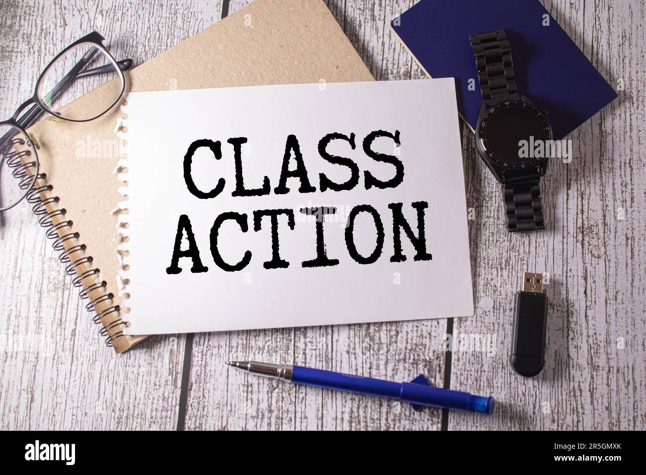 Class Action. text on notepad near torn paper Stock Photo - Alamy