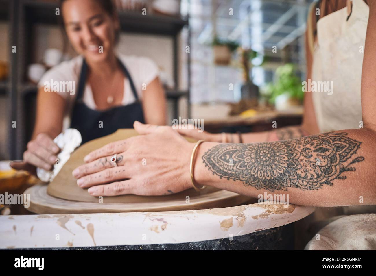 You learn something new everyday. two young women working with clay in ...