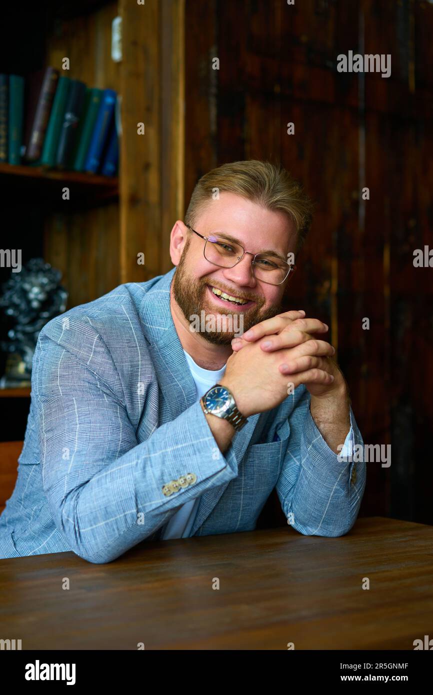 Guy in jacket sitting desk hi-res stock photography and images - Alamy