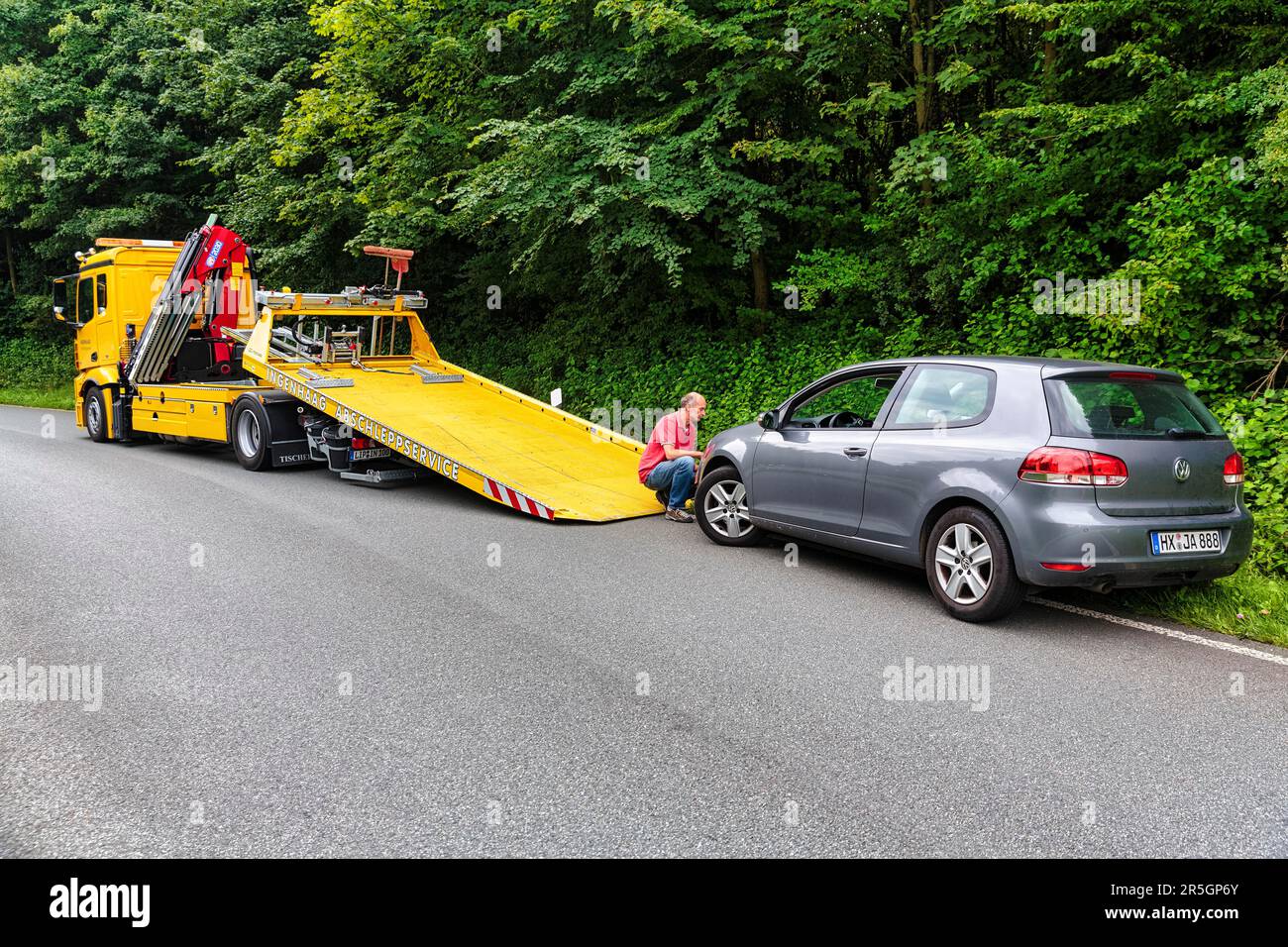 Defective VW Golf behind tow truck at roadside, car breakdown, North ...