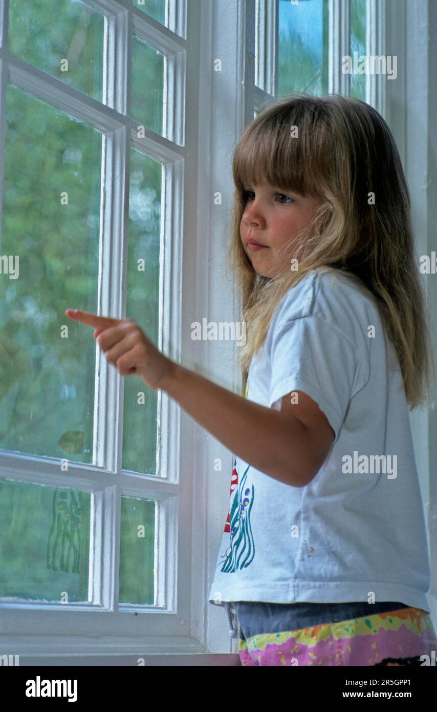 Little girl stands in the window, small girl stands in the window Stock ...