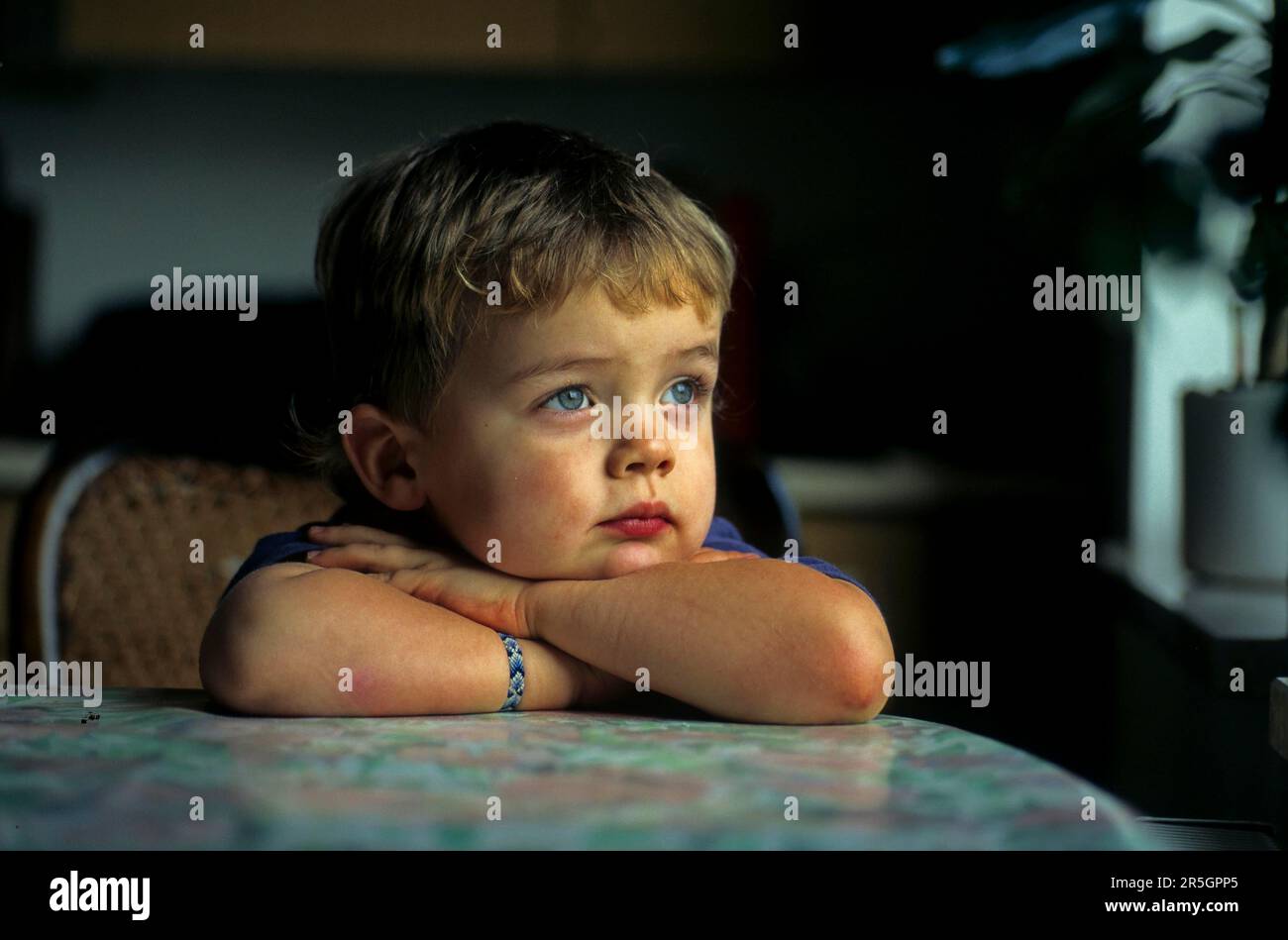 Child rests head on arms Stock Photo - Alamy