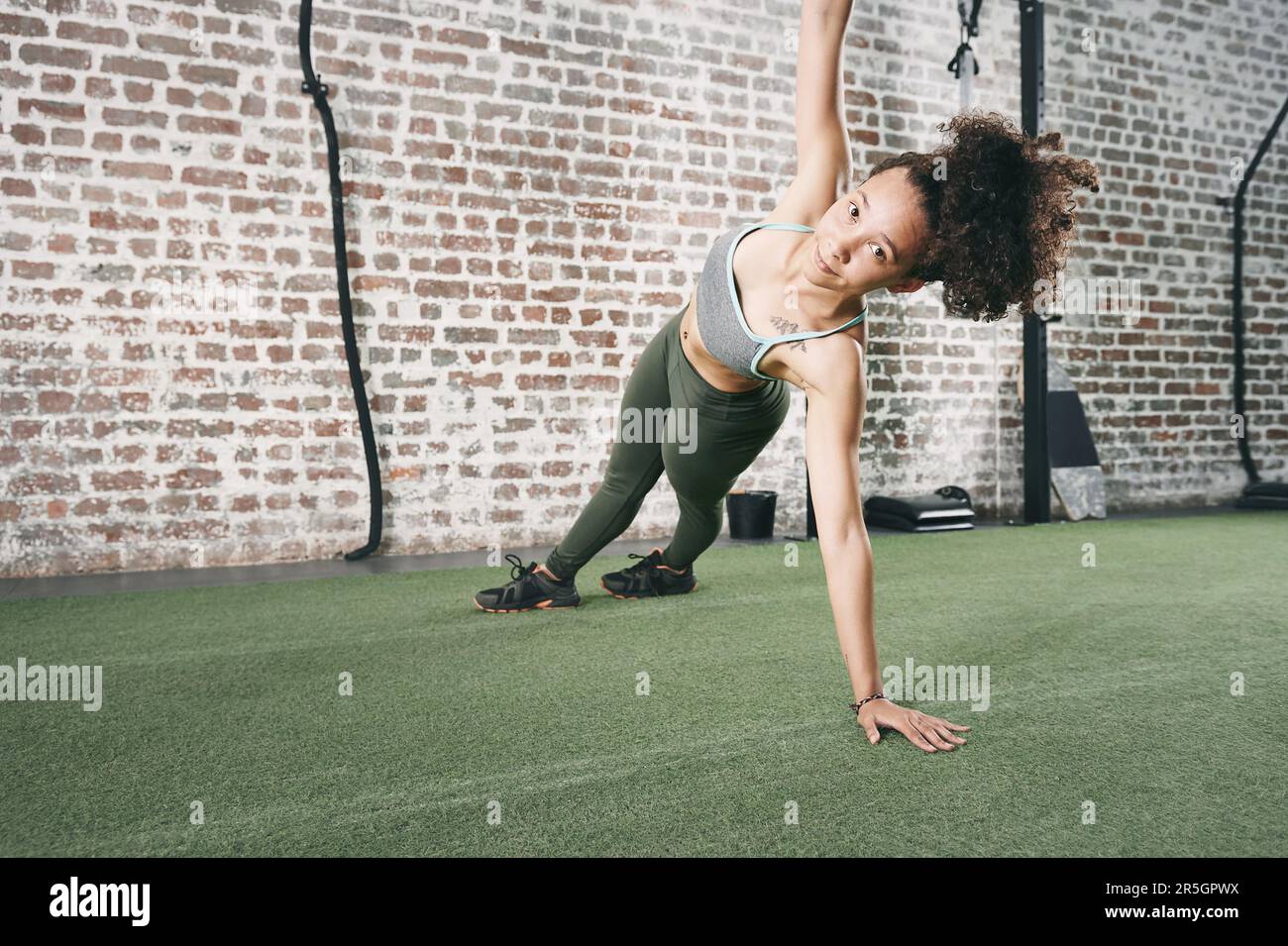 Include side planks in your core exercise routine. a sporty young woman ...