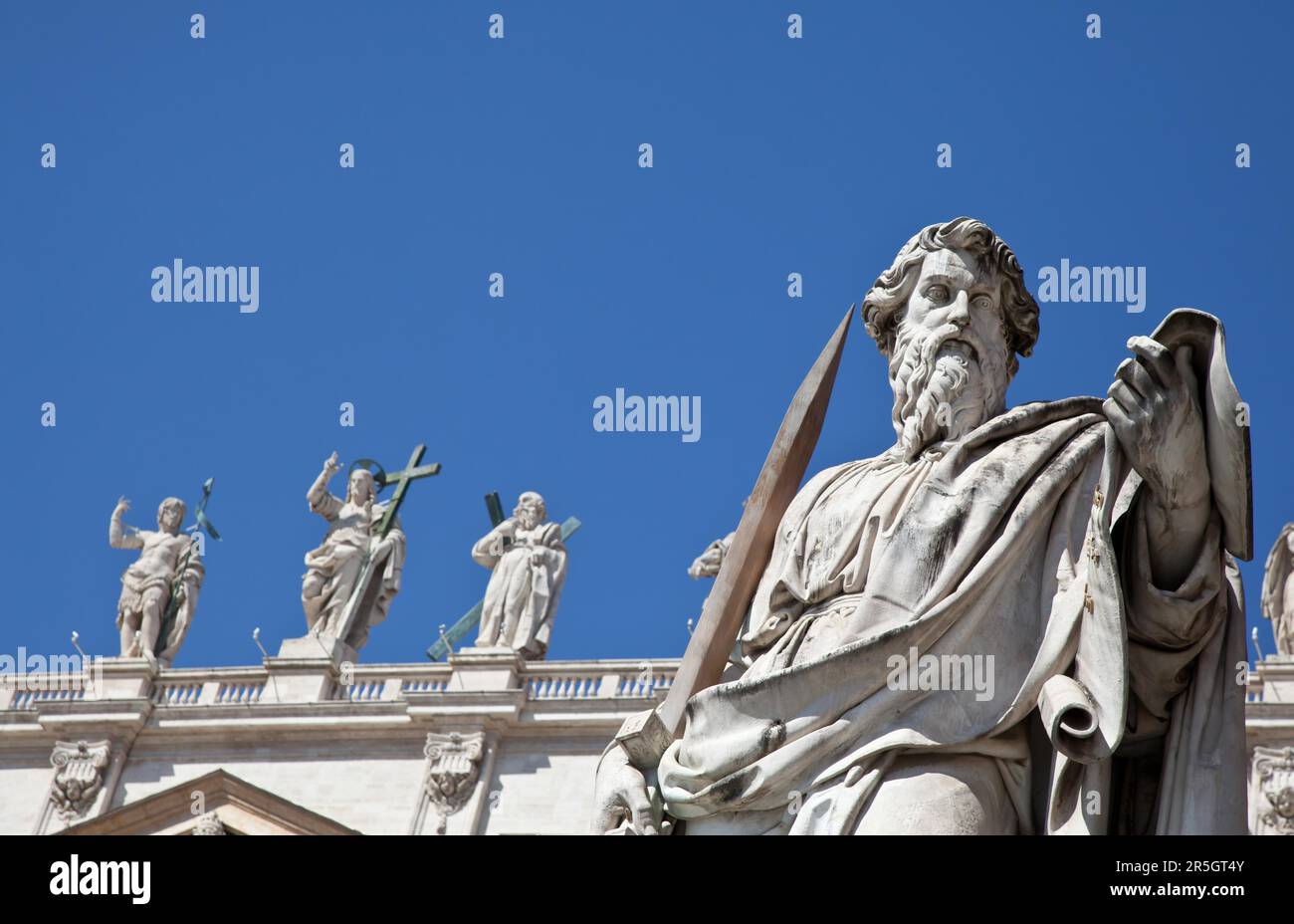 Statues in St. Peter Square (Rome) (Italy) with blue sky background ...