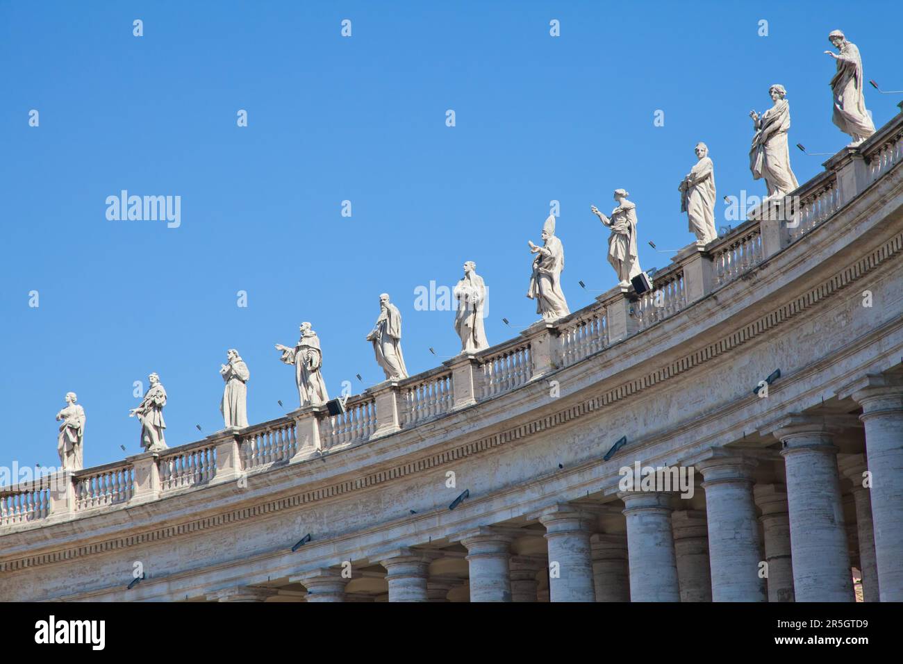 Statues in St. Peter Square (Rome) (Italy) with blue sky background ...