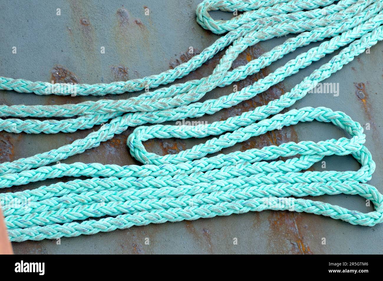 Old, frayed Blue Rope on the deck of a ship Stock Photo - Alamy
