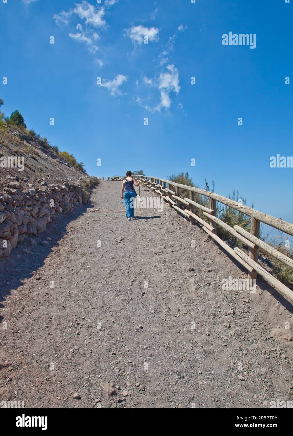 Lady walking for exercises during a sunny day on a mountain path Stock ...