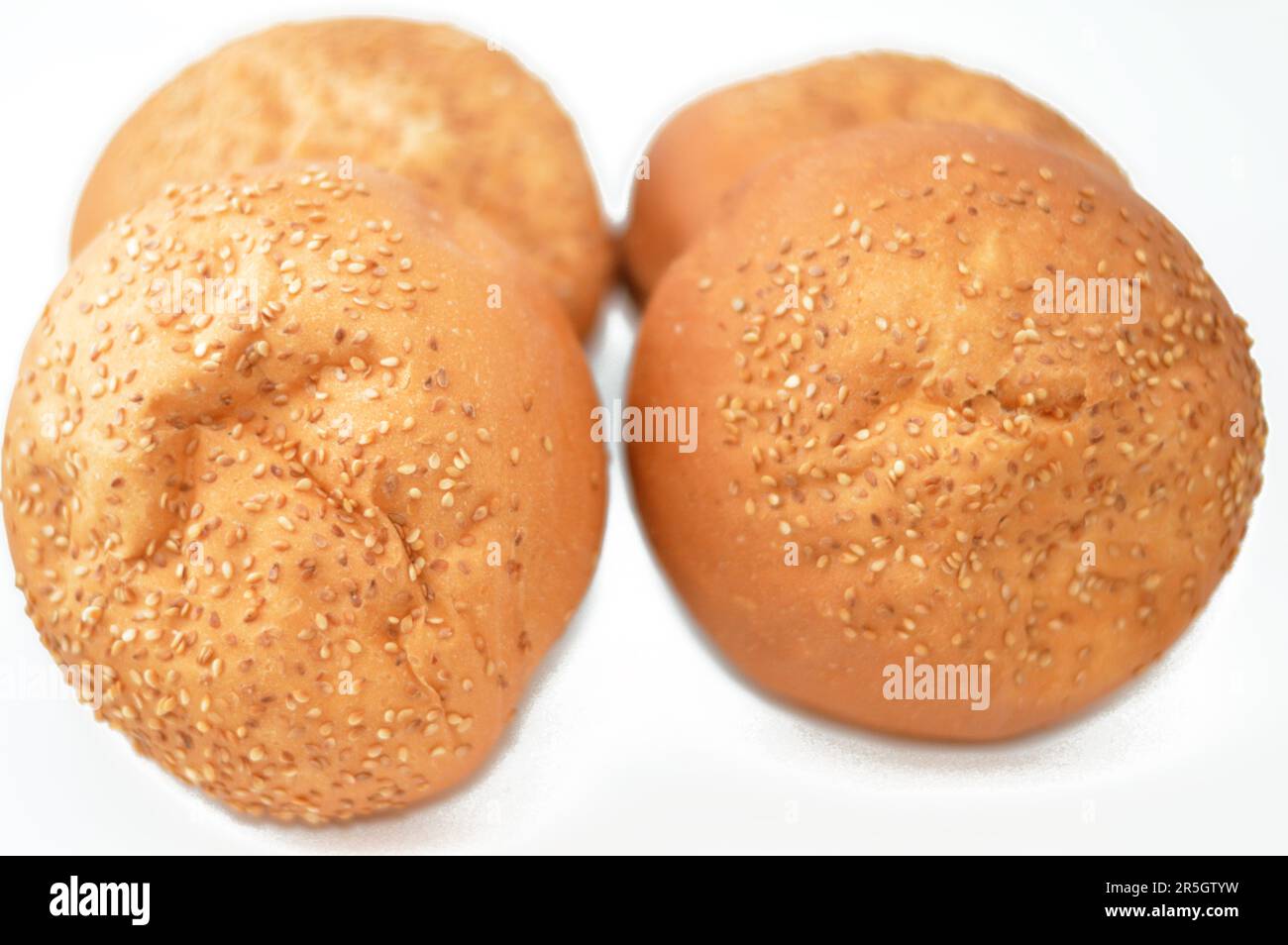 Round hand sized hamburger burger bun baked and covered with sesame ...