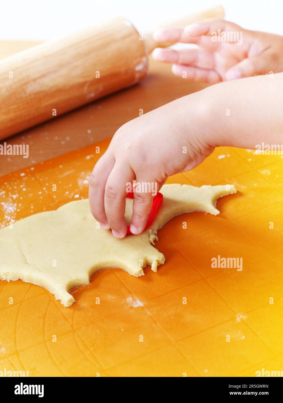Detail of hands cutting pastry Stock Photo - Alamy