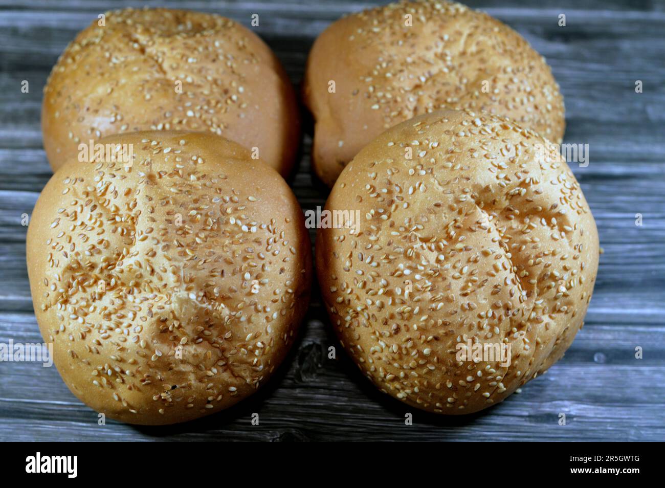 Round hand sized hamburger burger bun baked and covered with sesame ...