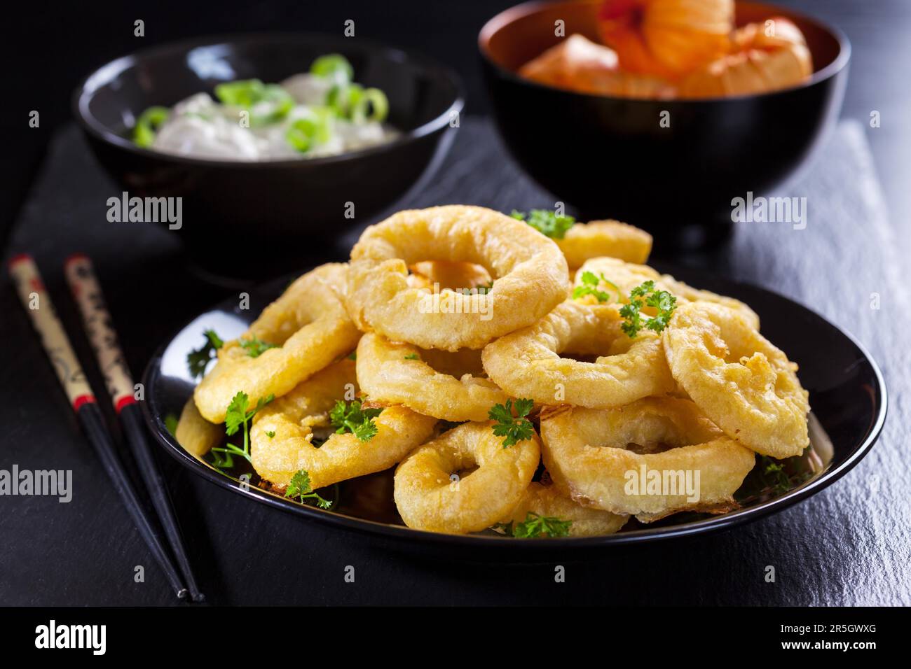 Calamari rings with yogurt garlic dip Stock Photo - Alamy