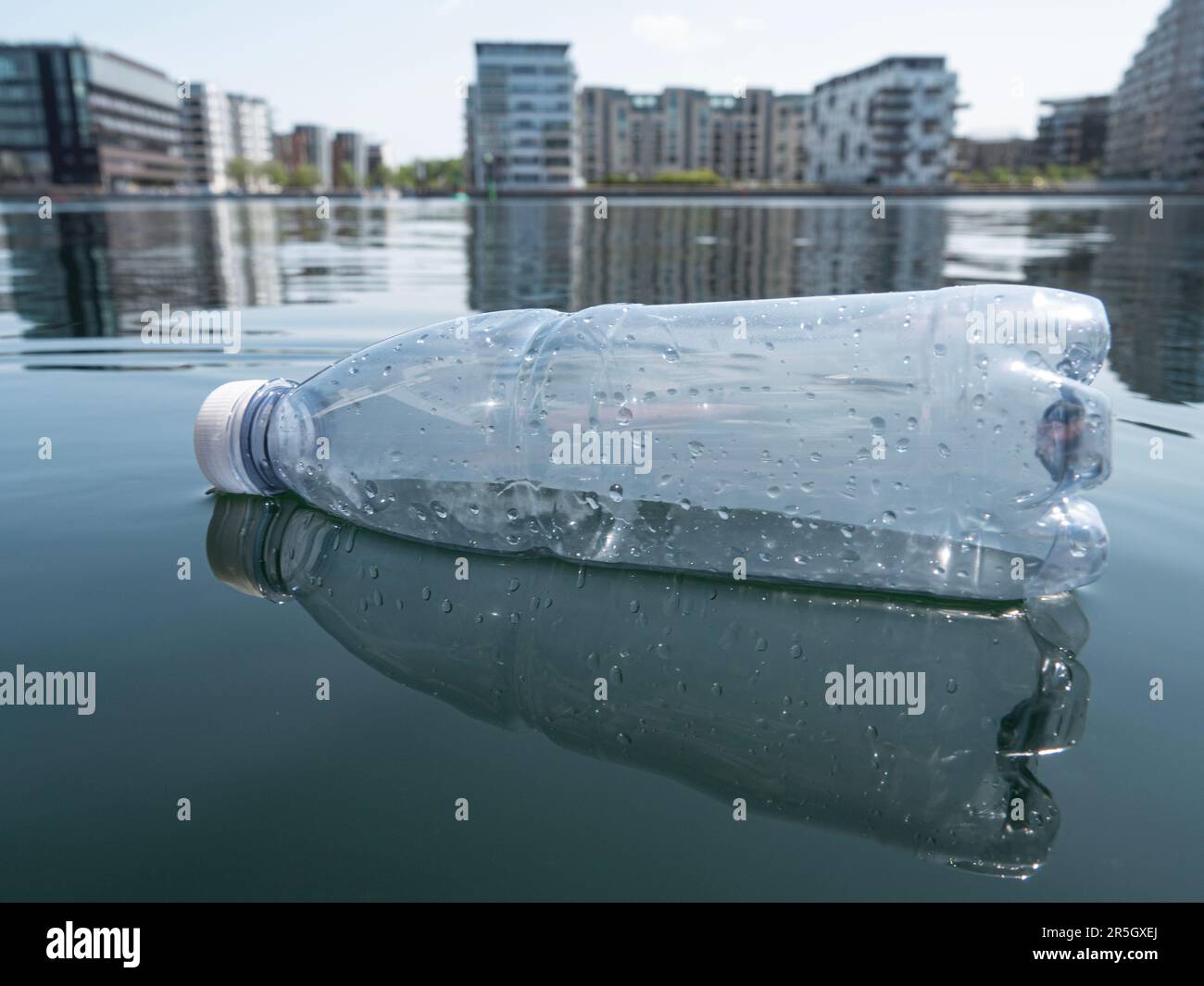 Environmental pollution - plastic bottle floating in sea water in urban ...