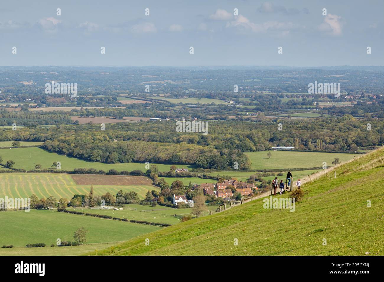 People waking over the rolling Sussex countryside near Brighton Stock ...