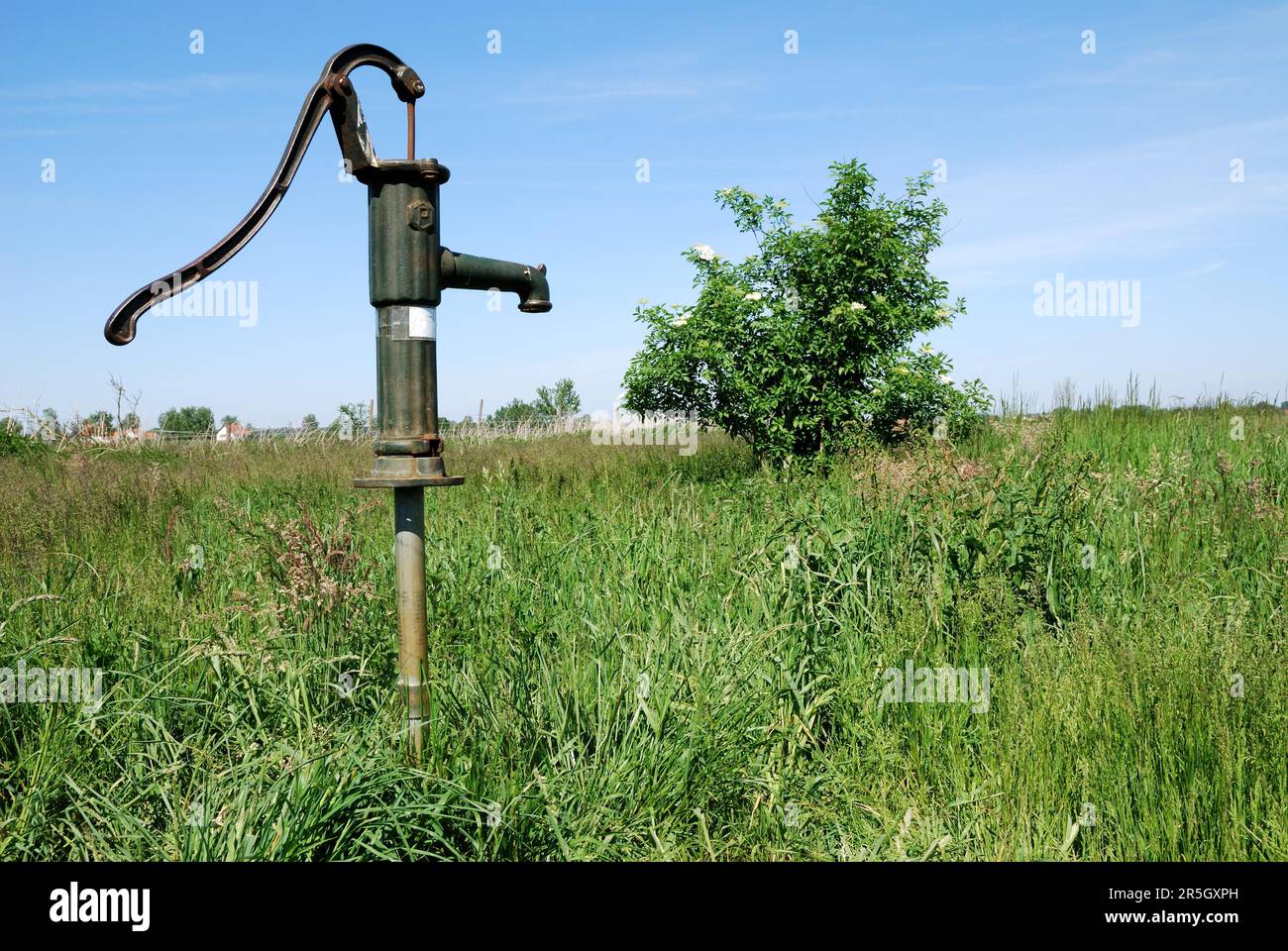 Water pump in a bavarian landscape Stock Photo - Alamy