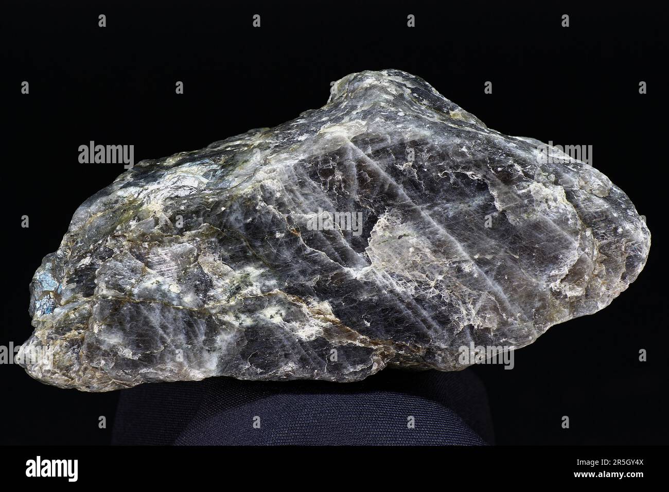 Plagioclase (feldspar) - unworked rock specimen on dark background ...