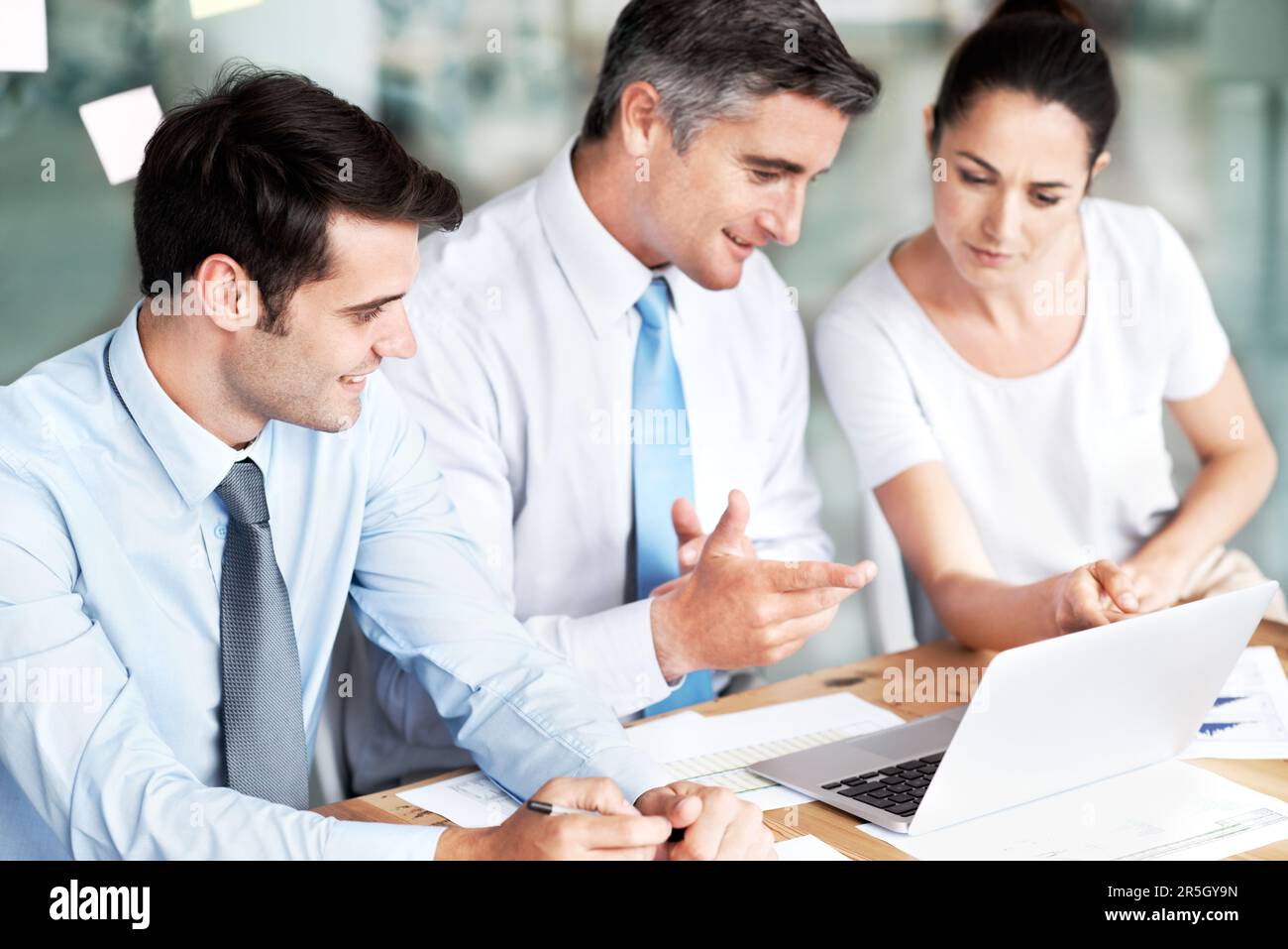 Explaining his ideas. Group of businesspeople working together on a ...