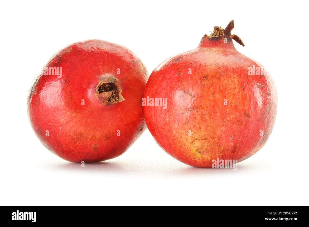 Two pomegranates isolated on white Stock Photo - Alamy