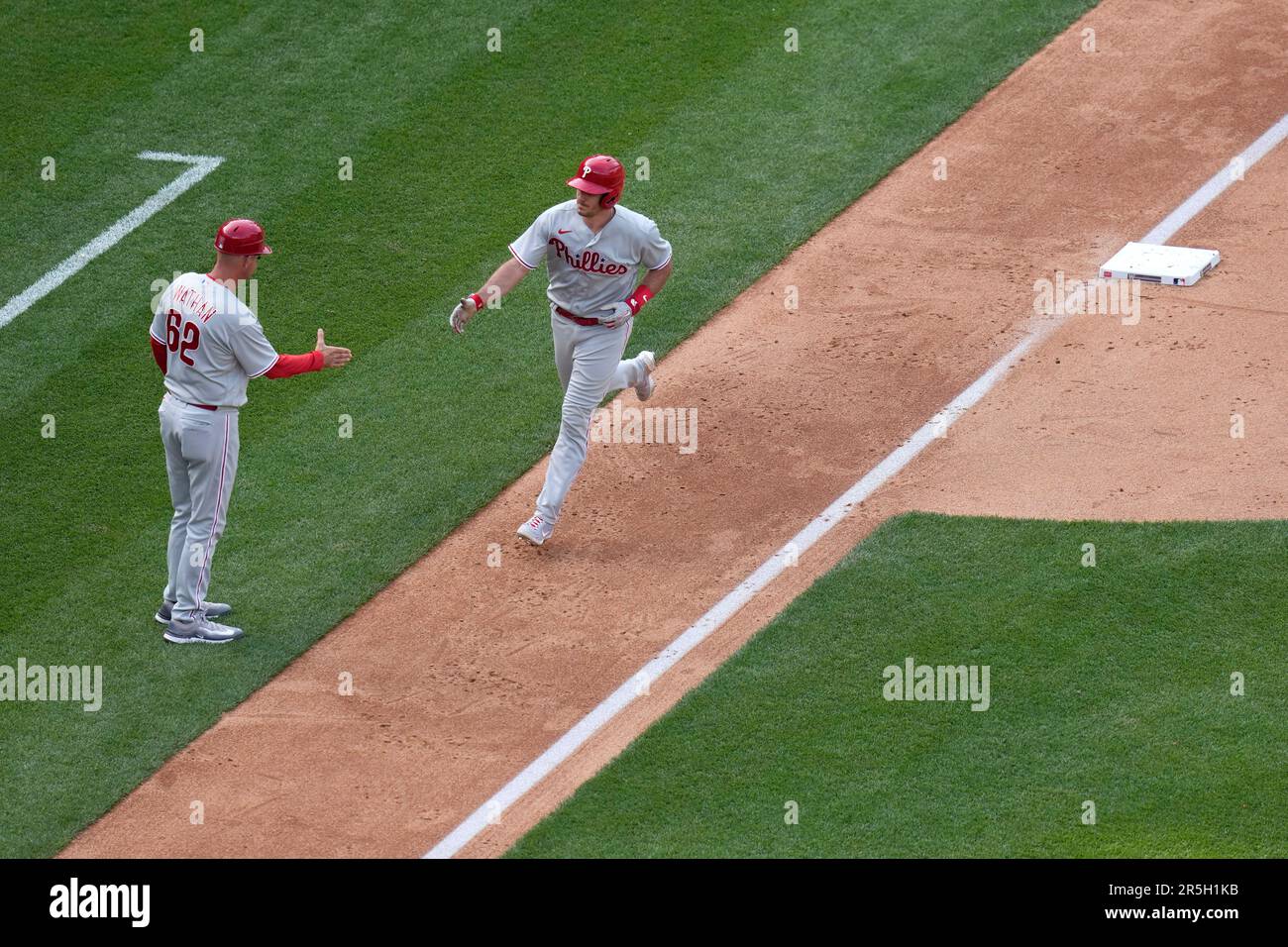 Philadelphia Phillies' J.T. Realmuto rounds the bases past third base ...