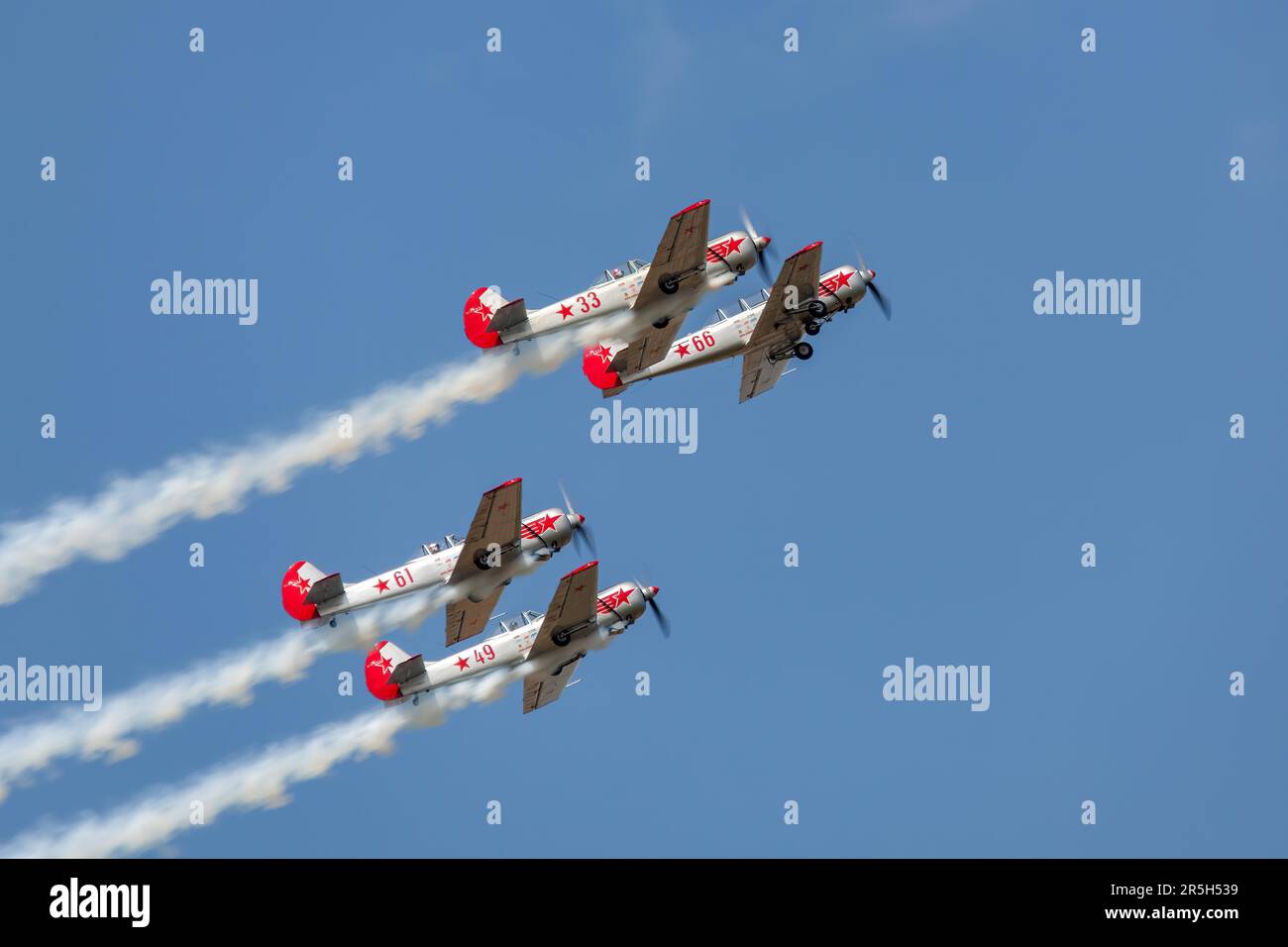 Four Yakovlev Yak-52/50 planes in tight formation Stock Photo - Alamy
