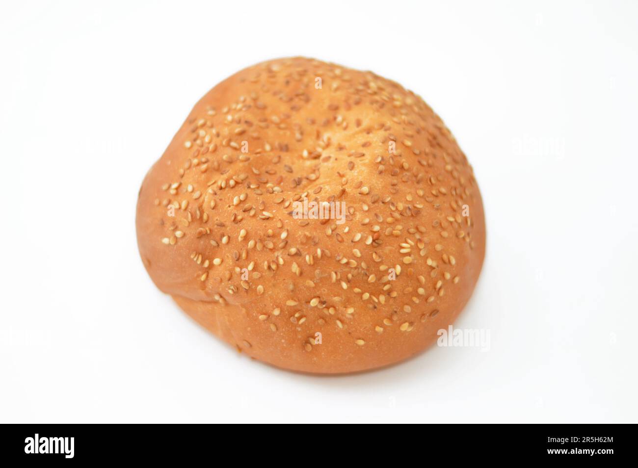 Round hand sized hamburger burger bun baked and covered with sesame ...