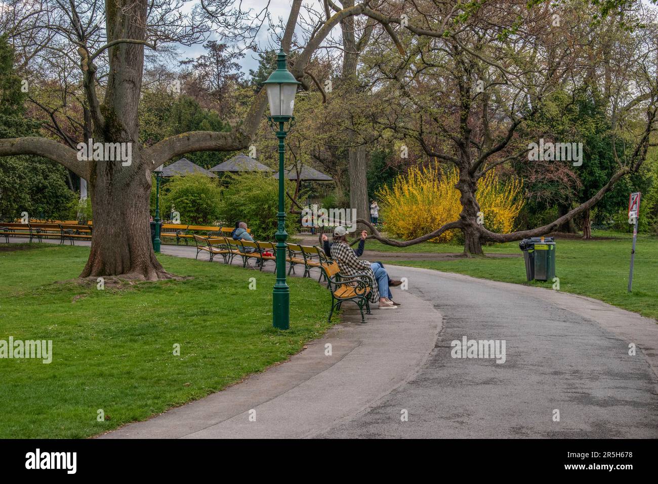 vienna, austria. 9 april 2023 stadtpark (city park) embracing tranquility as people relax on ...