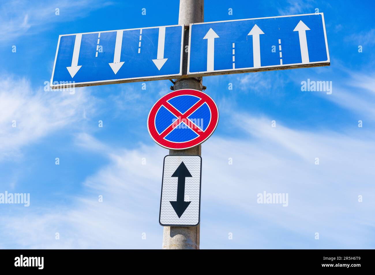 A traffic sign prohibiting car parking (red cross on blue circle) with ...